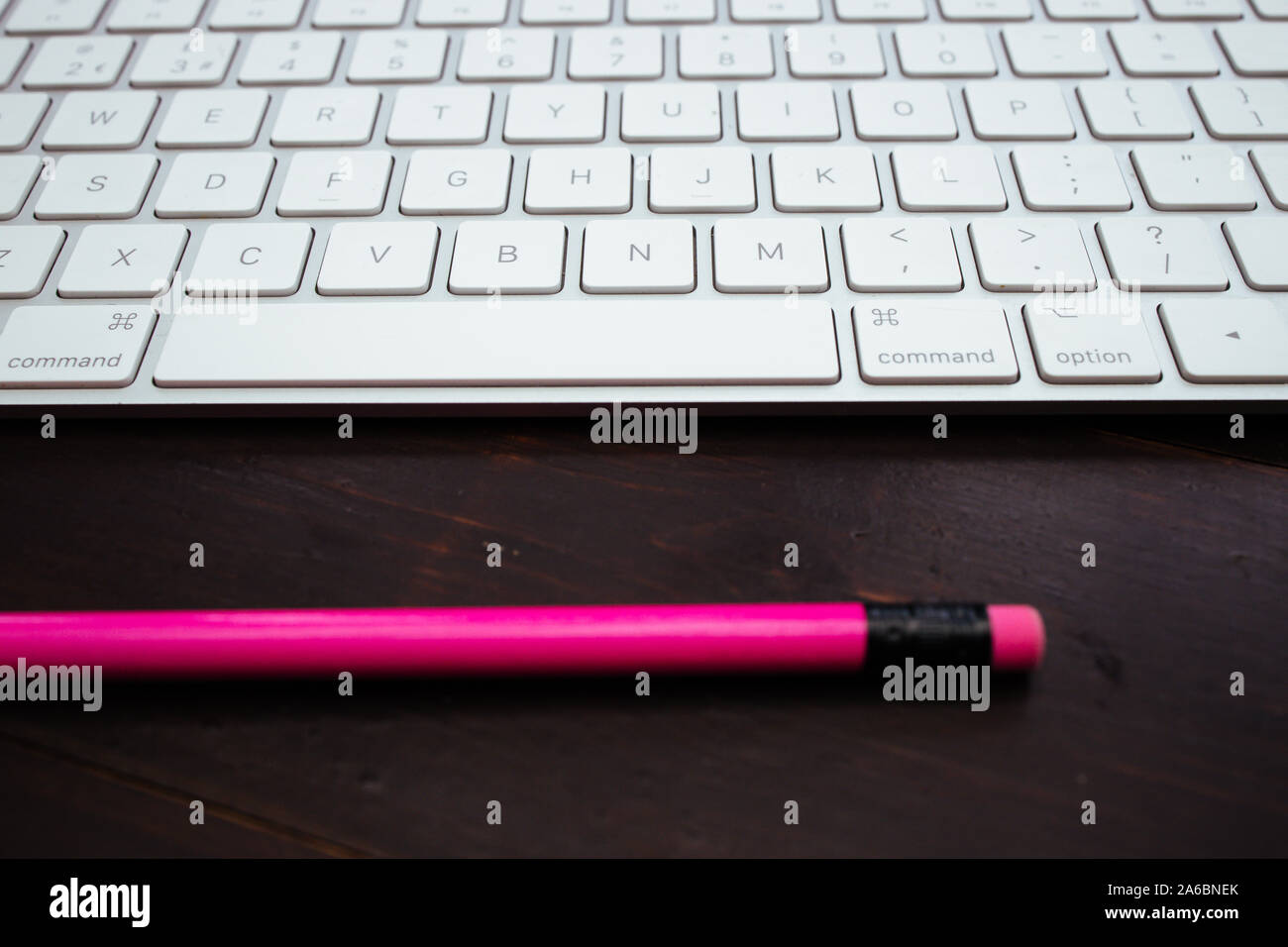 Computer keyboard top view on dark brown wood texture table desk office ...