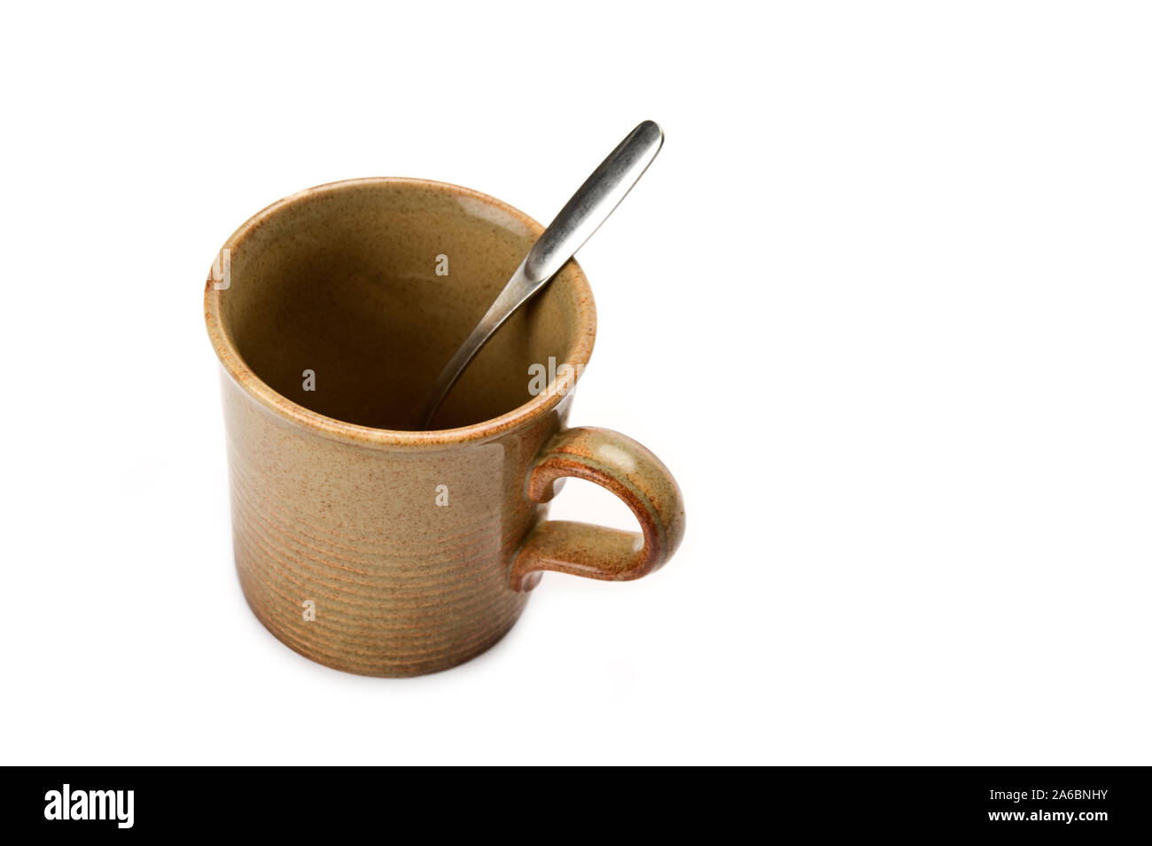 Empty mug with spoon on white background Stock Photo - Alamy