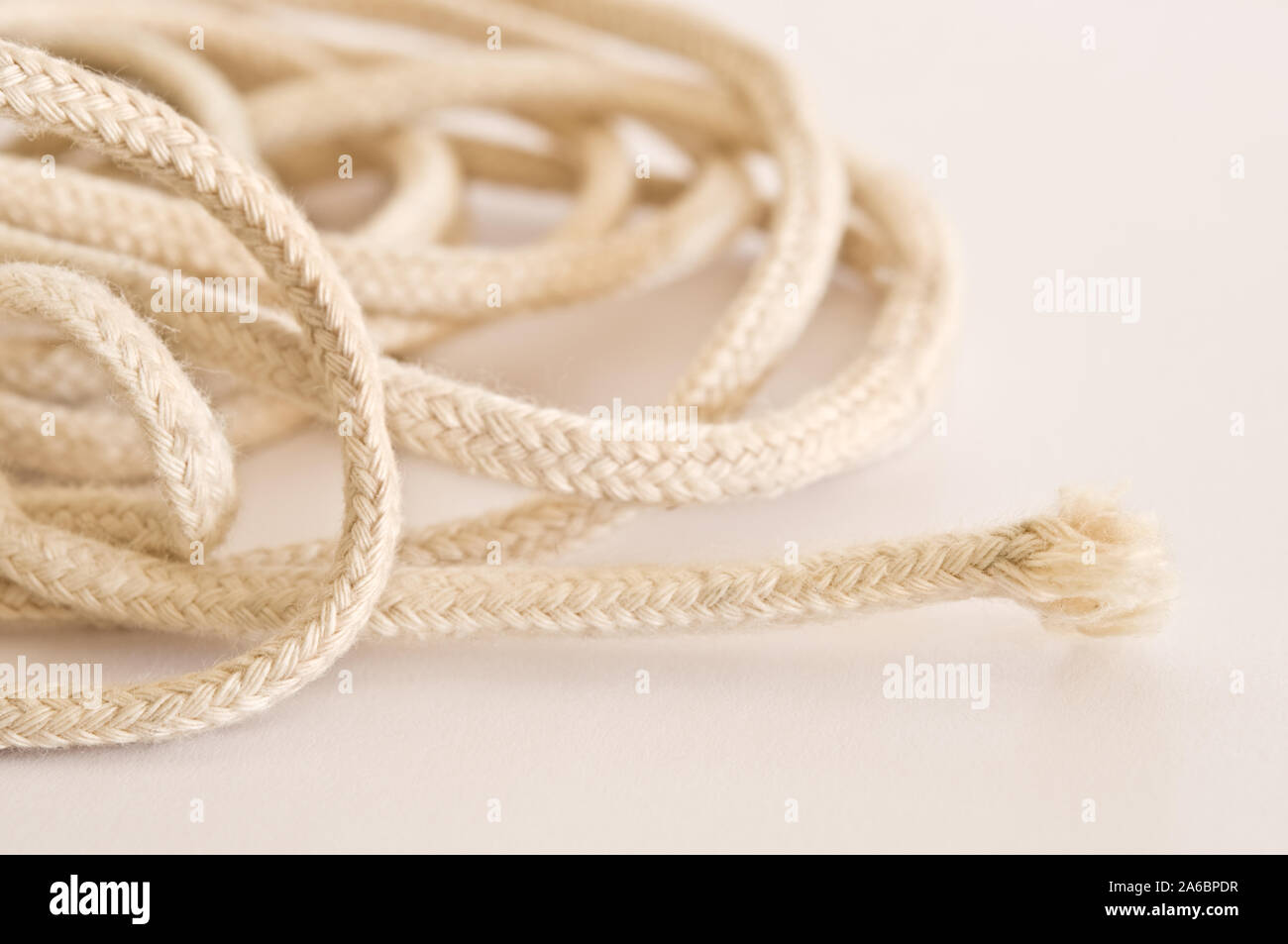 Tangled rope on white background. Selective focus and shallow depth of ...