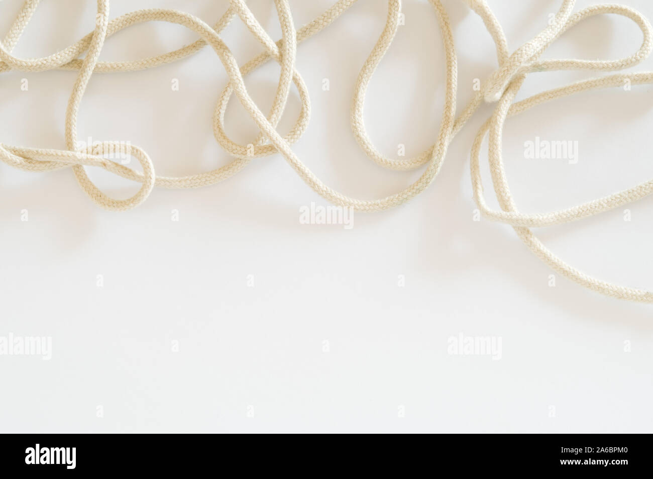 Tangled string on white background Stock Photo - Alamy