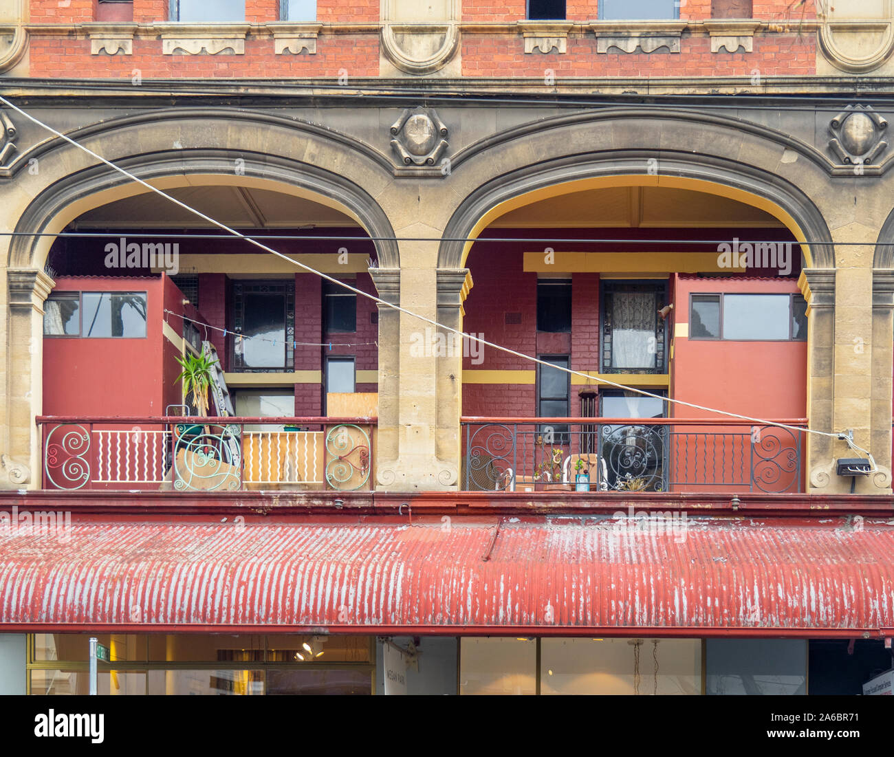 Balcony and red tin verandah of Federation style red brick building on ...