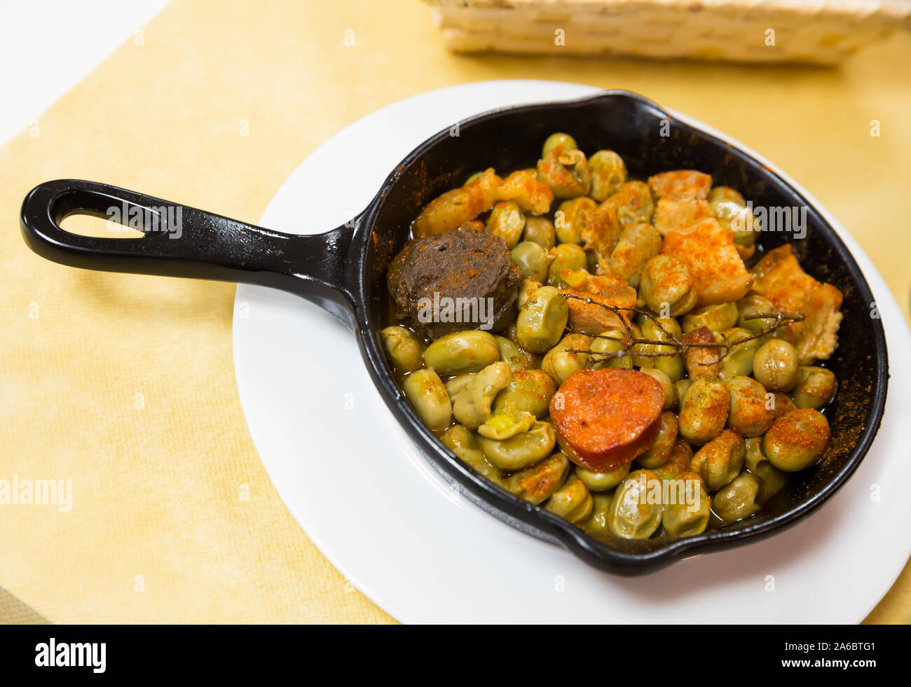 Popular Catalan style beans cooked with sliced blood sausage, chorizo ...