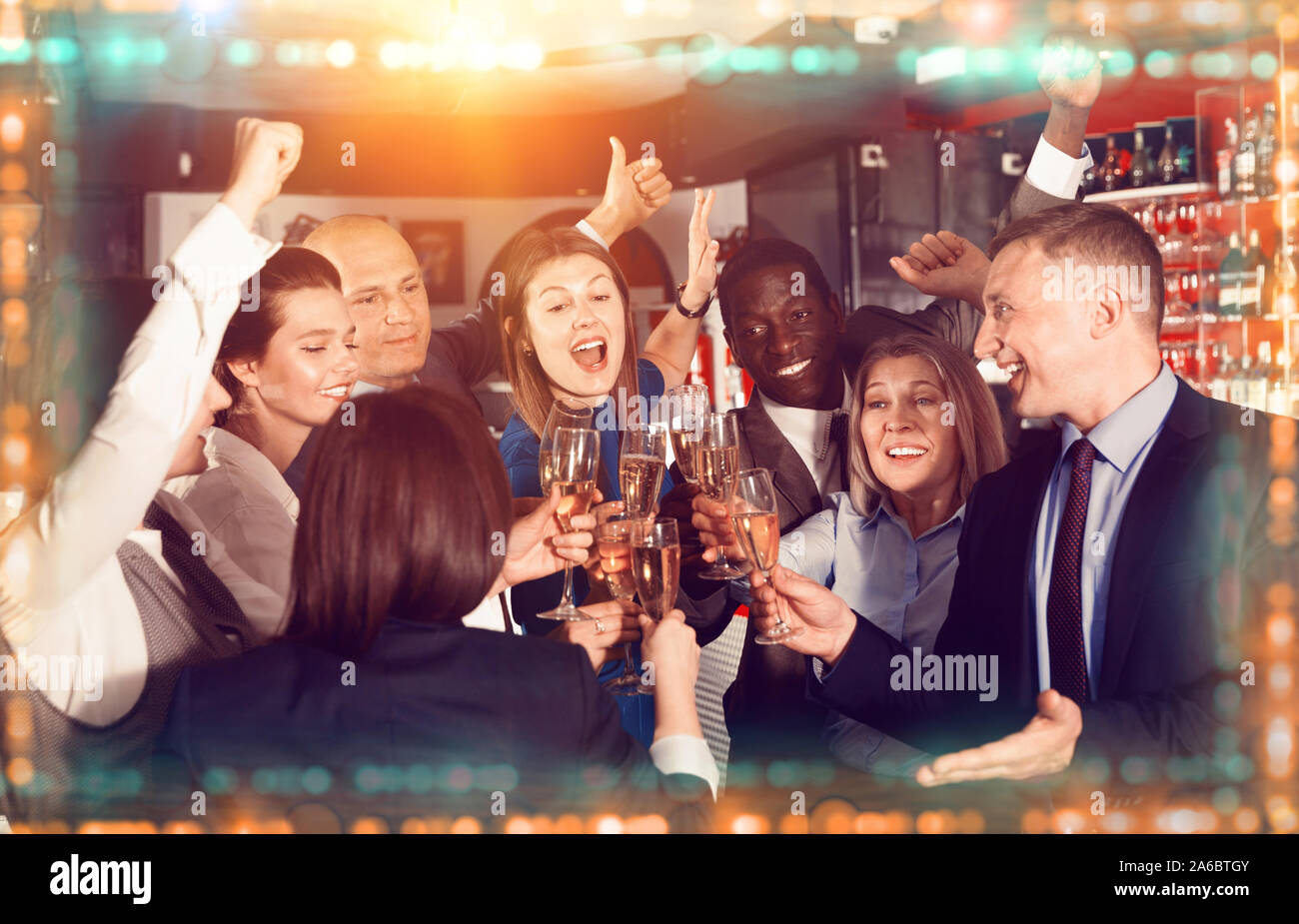 International group of positive businesspeople toasting with champagne ...