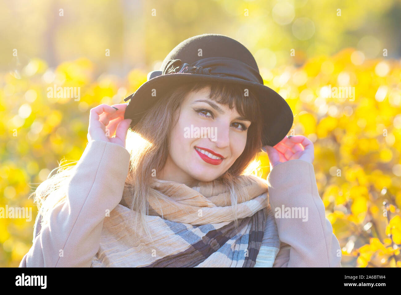 A pretty woman of 30 years old with a beautiful smile in a hat and coat ...