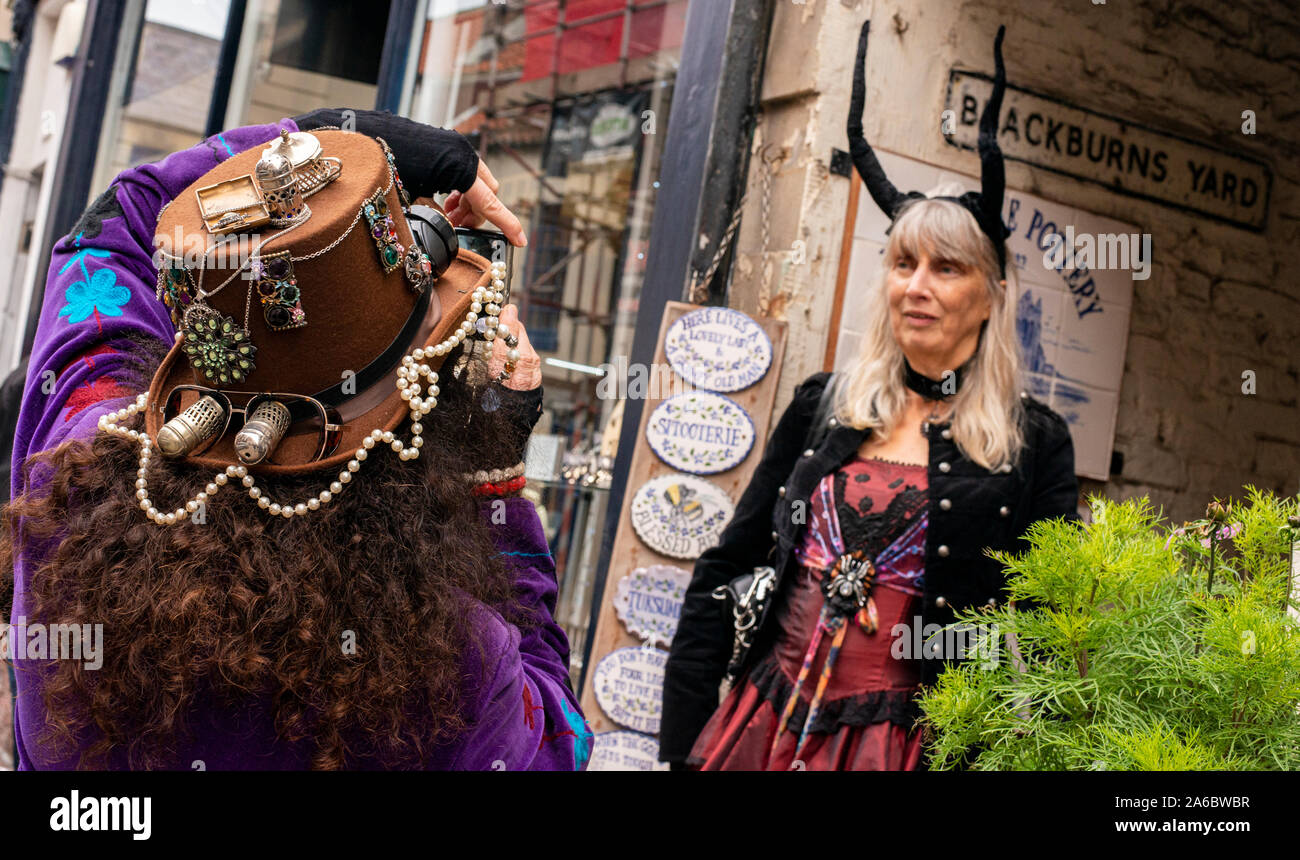 Two friends in traditional Goth costumes taking photograph, Whitby Goth ...