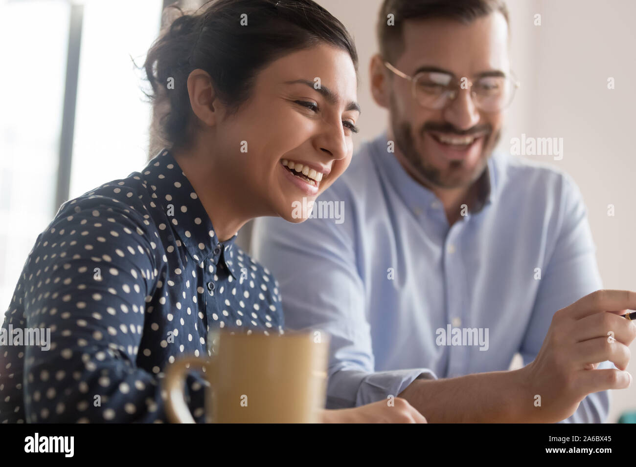 Diverse office workers couple having a coffee break Stock Photo - Alamy