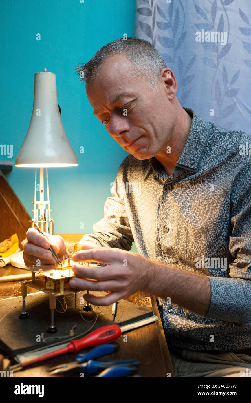 Repairing clock hi-res stock photography and images - Alamy