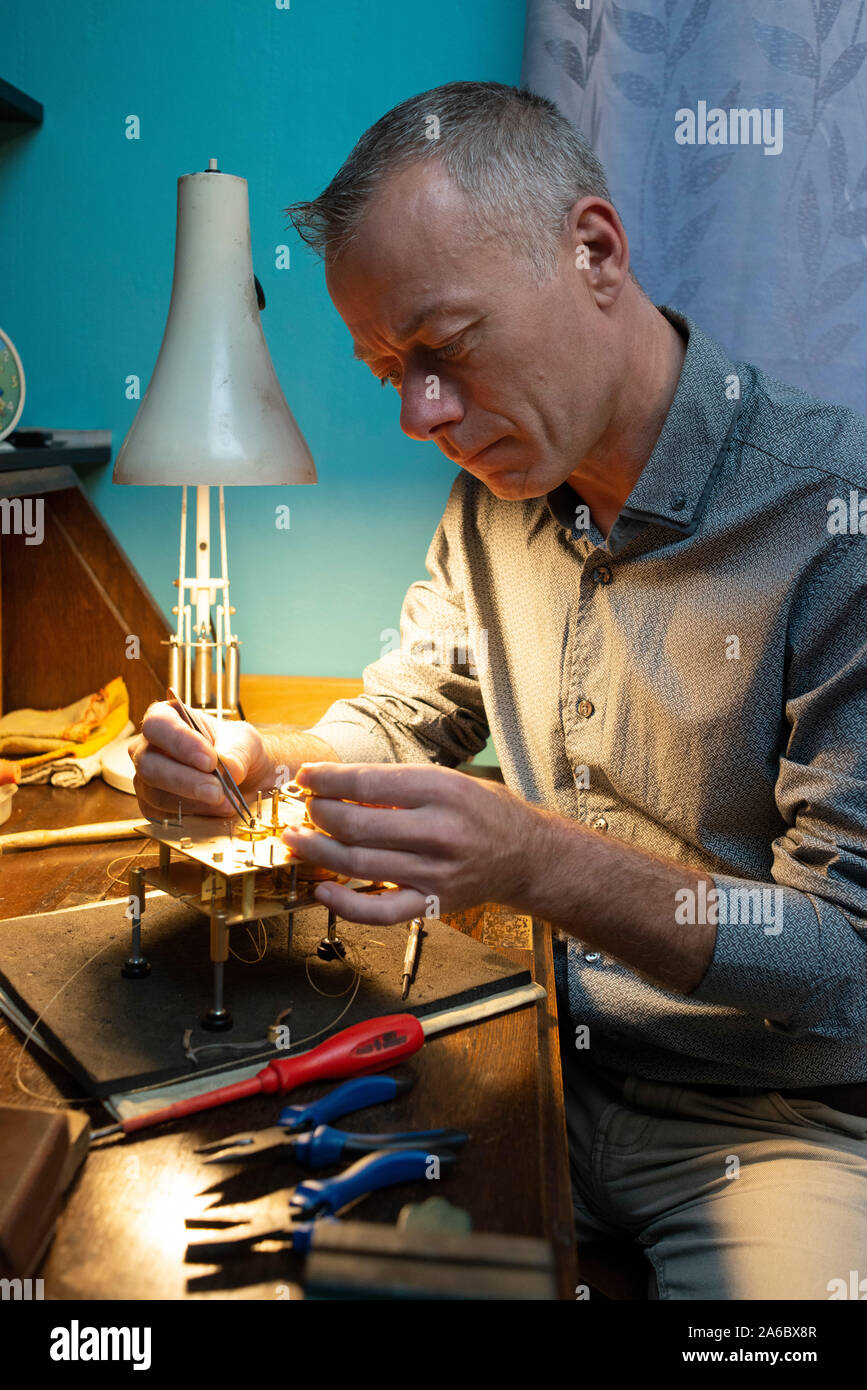 Repairing clock hi-res stock photography and images - Alamy