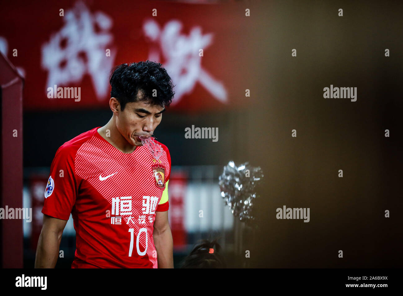 Zheng Zhi of Guangzhou Evergrande spits out water during their second ...