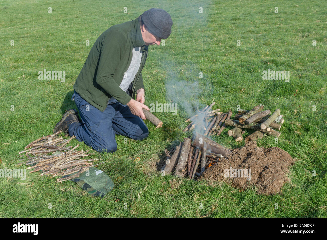 Adding a log to the fire hi-res stock photography and images - Alamy