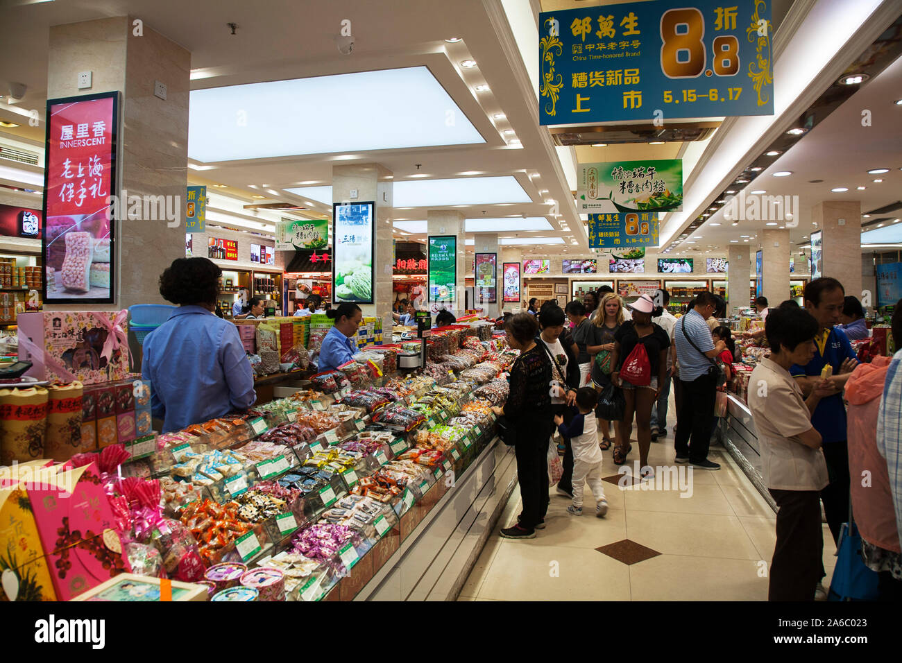 Local market with confectionary stall in downtown shopping district ...