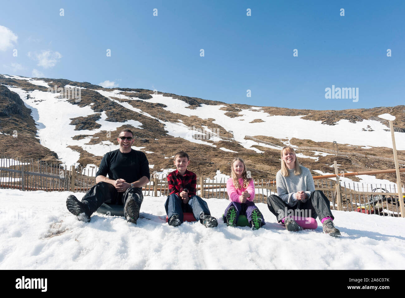 A family go sledging in Glen Coe, Scotland Stock Photo - Alamy