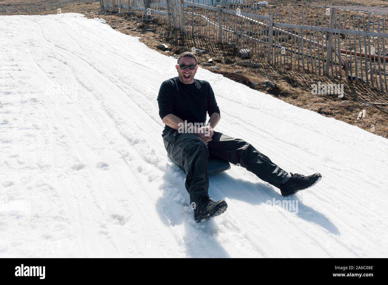 A family go sledging in Glen Coe, Scotland Stock Photo - Alamy