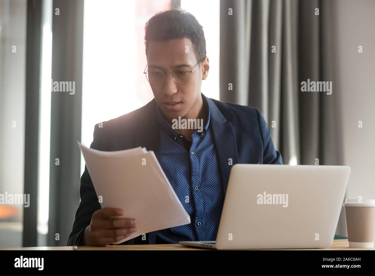 African guy reading paper hi-res stock photography and images - Alamy