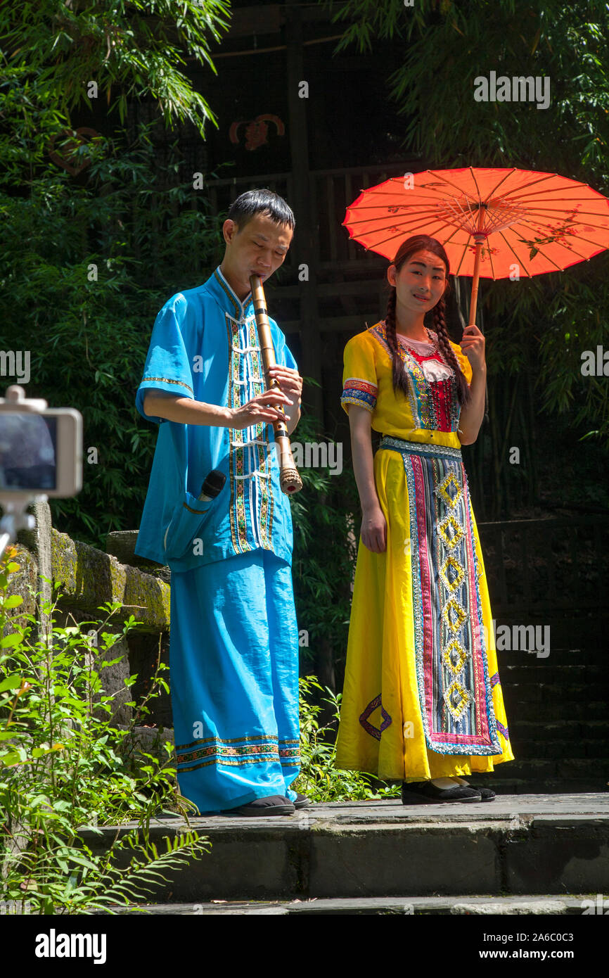 Chinese man and women in traditional dress at Tribe of The Three Gorges ...