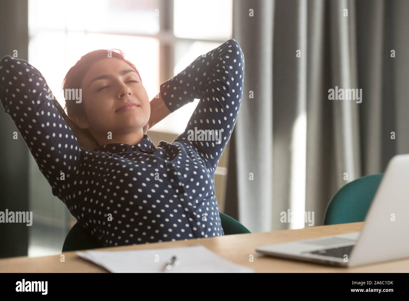 Millennial young indian woman relaxing after hard working day Stock ...