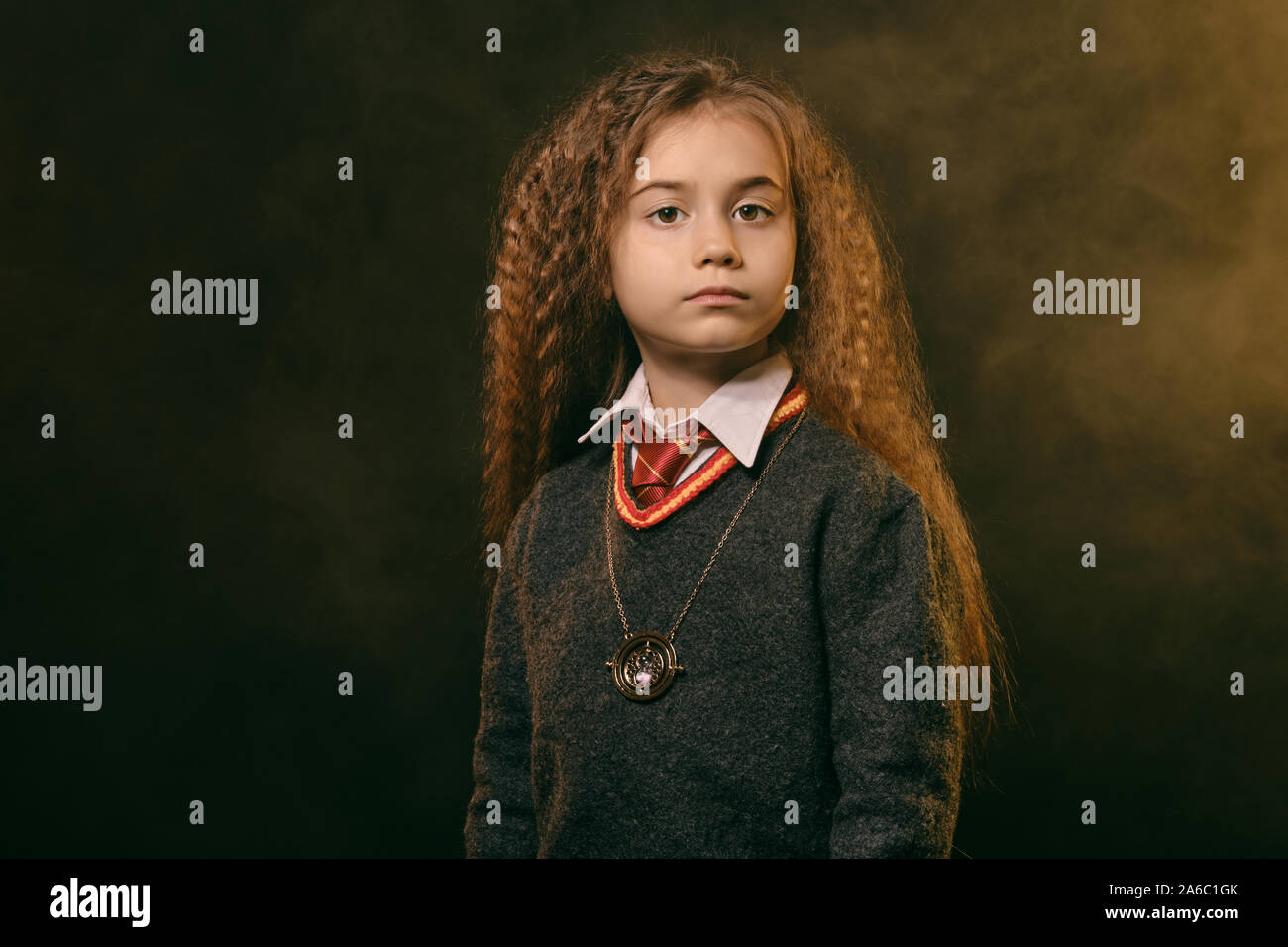 Portrait of a lovely little charmer with magnificent long brown hair ...