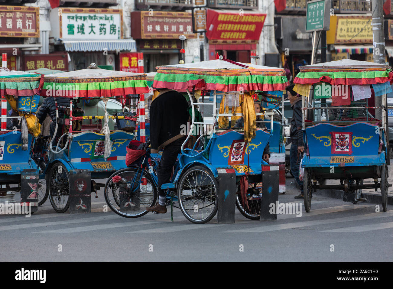 Pedicabs or bicycle rickshaws wait for passengers in Lhasa, Tibet. The ...