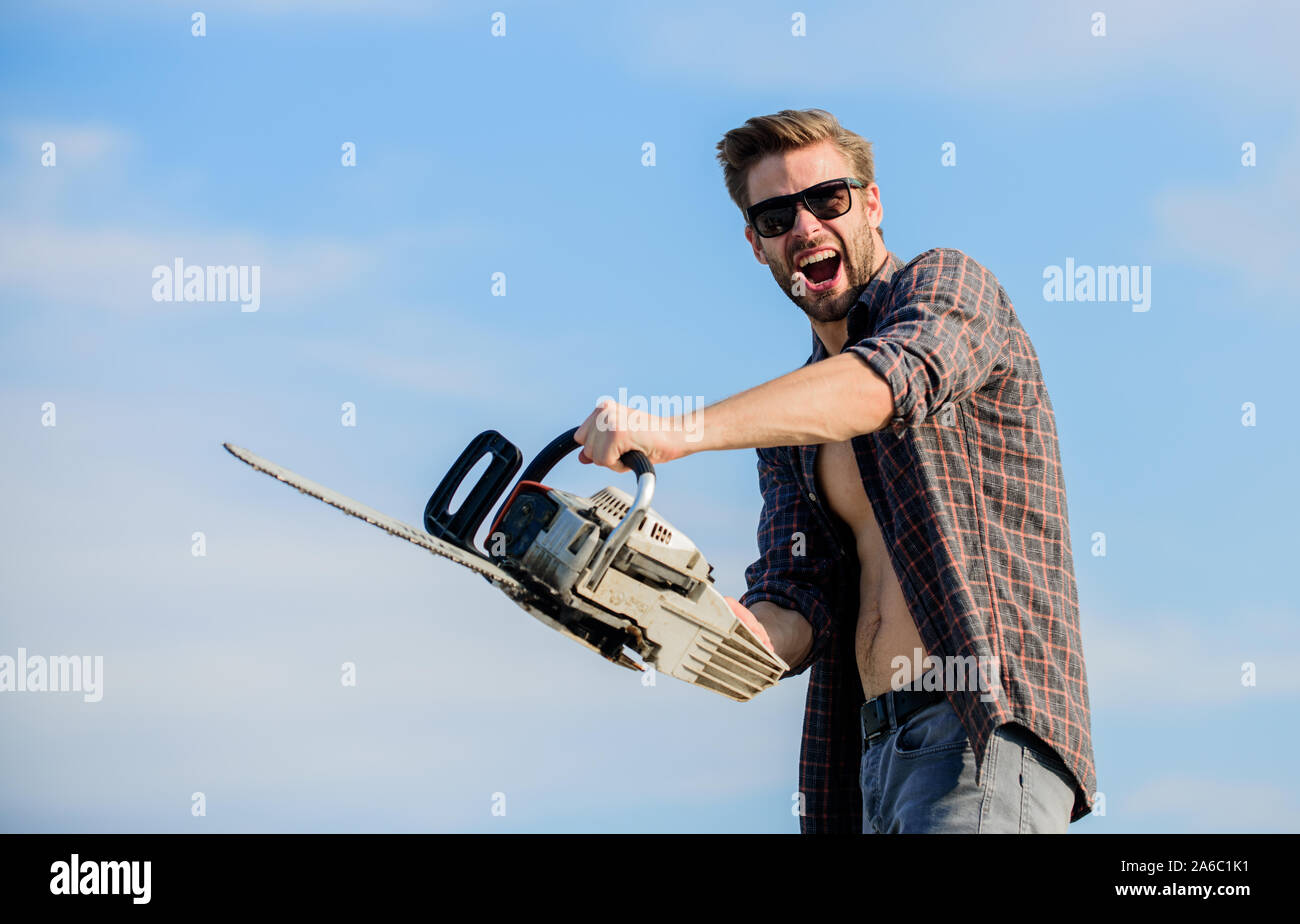 Lumberjack with chainsaw in his hands. Masculinity concept. Sharp blade ...
