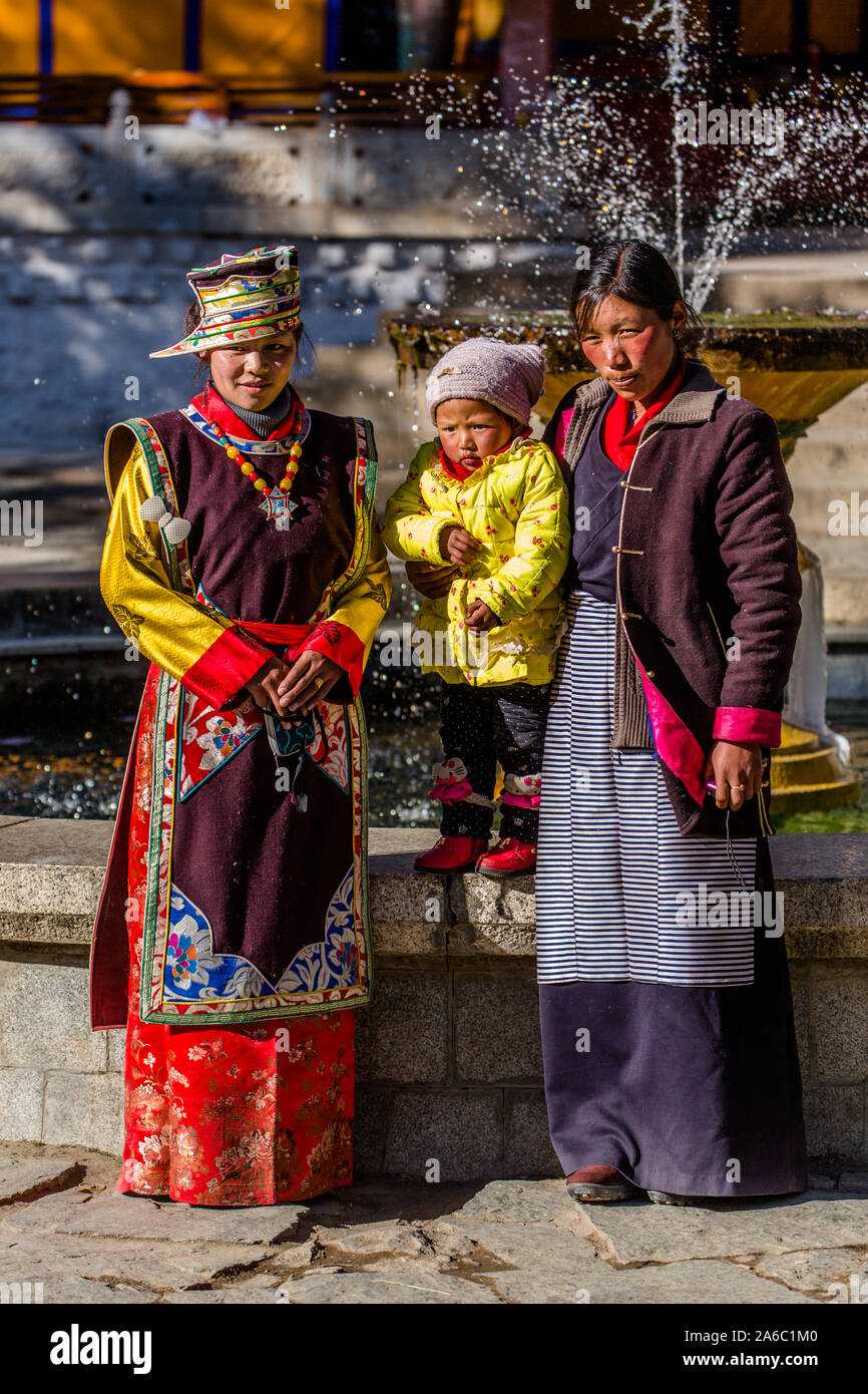 A Tibetan woman in festive dress in Lhasa, Tibet, along with a Khamba ...