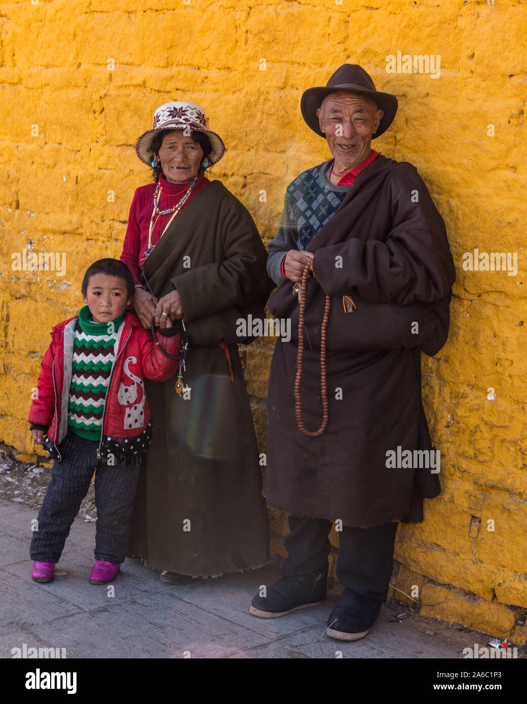 Tibetan grandparents with their grandson in Lhasa, Tibet. The man is ...