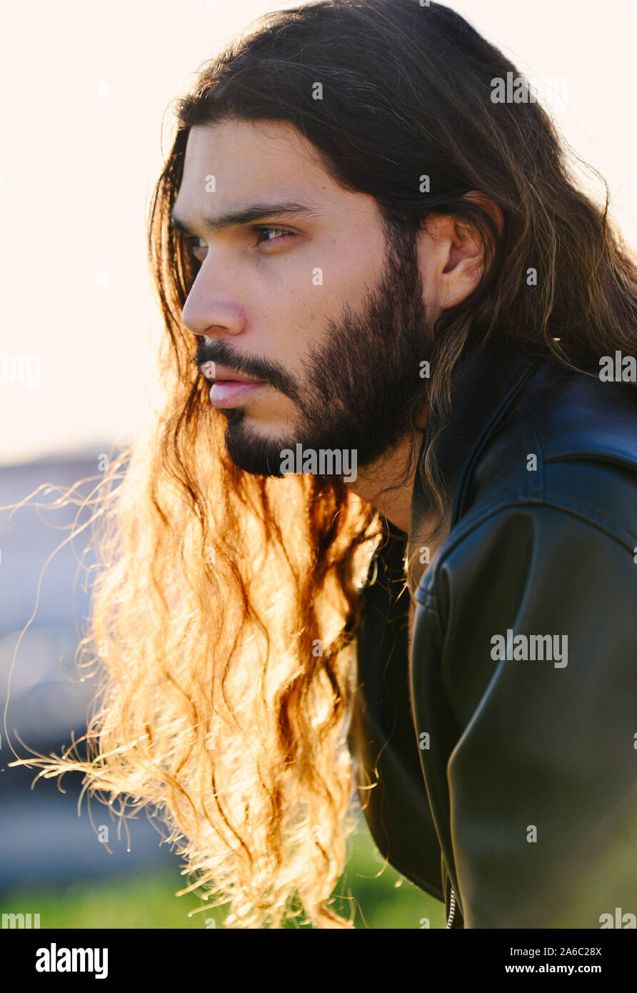 Handsome young Colombian man with long hair Stock Photo - Alamy