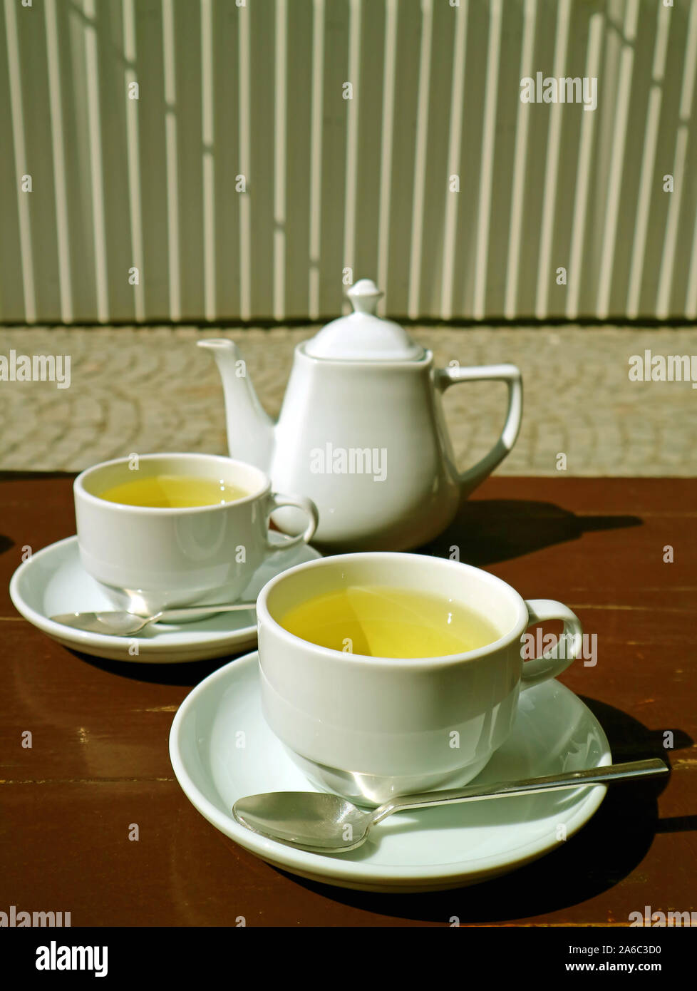Vertical image of a tea set on the table at outdoor seating Stock Photo ...