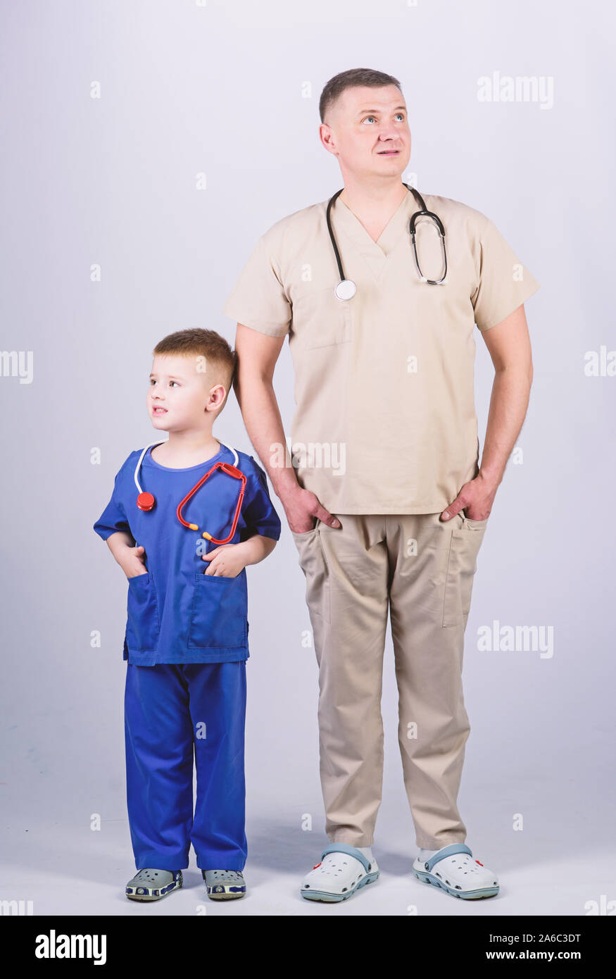 medicine and health. family doctor. father son in medical uniform ...