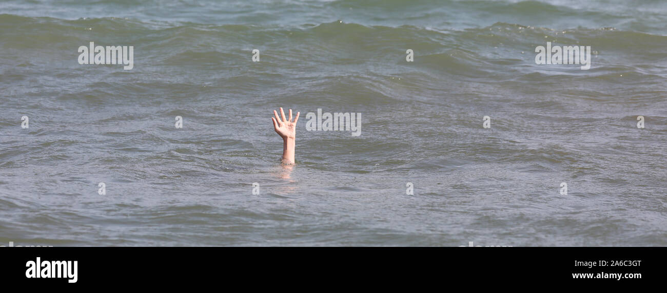 hand of the person during the drowning in the ocean asking for help ...