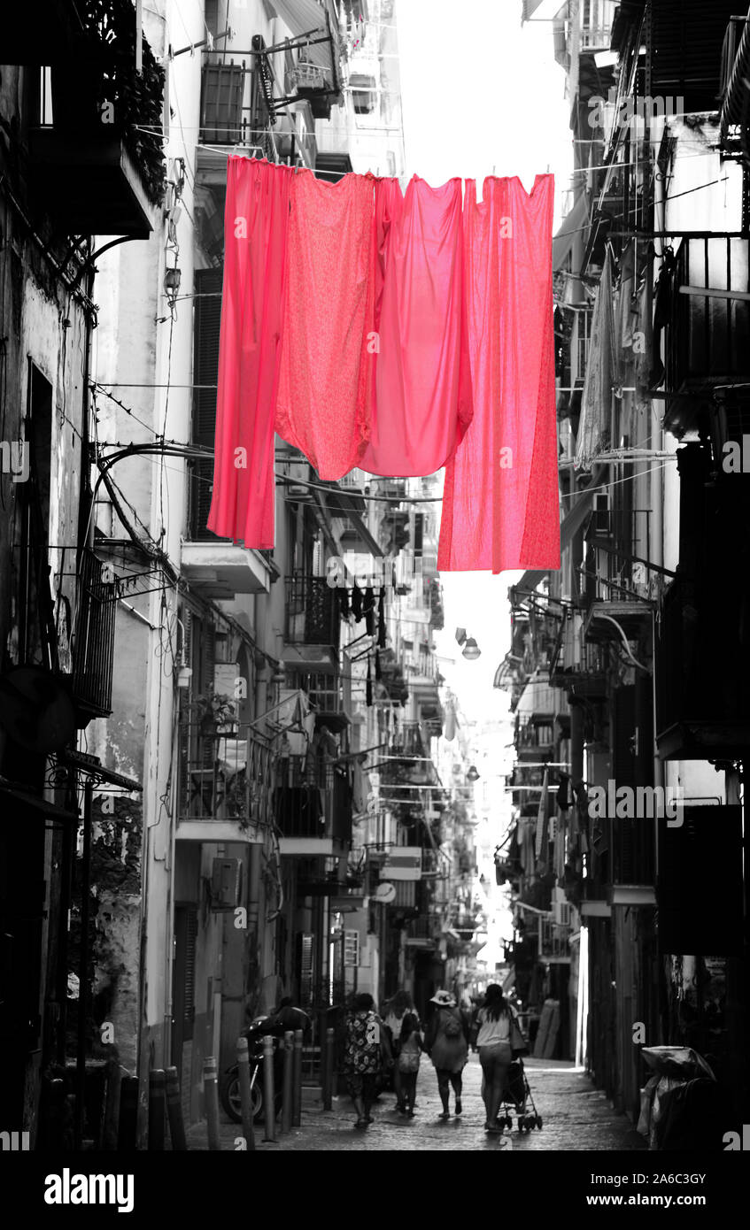red hanging bedclothes on the narrow street in Naples City in Italy in ...