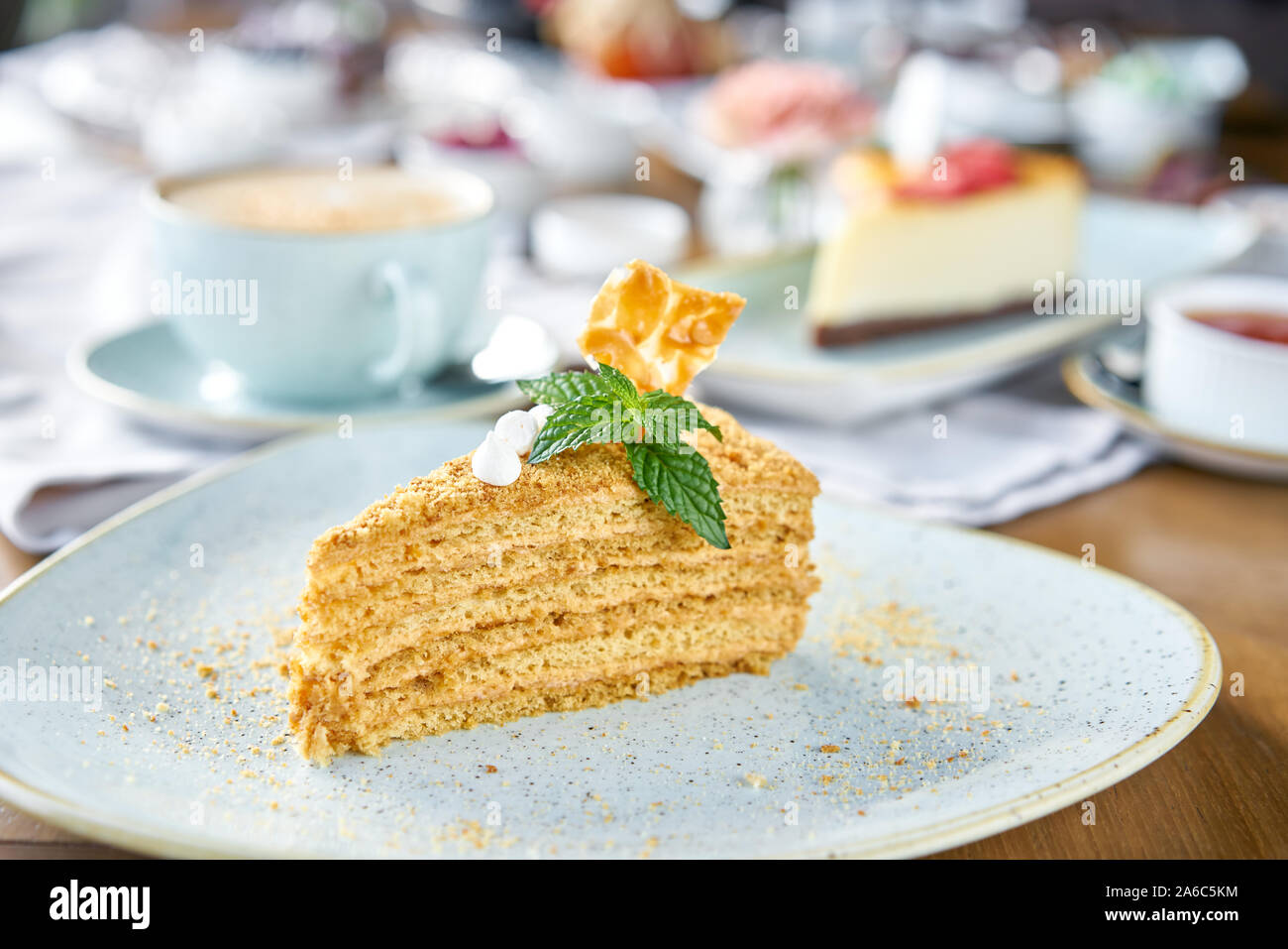 Honey sponge cake decorated with meringue and mint leaves.. Breakfast ...