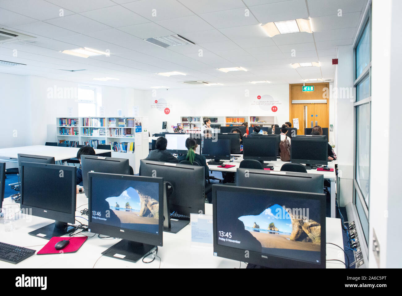 International students reading and working in the college library Stock ...