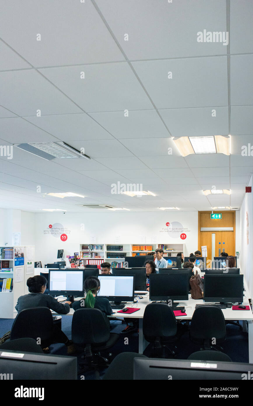 International students reading and working in the college library Stock ...