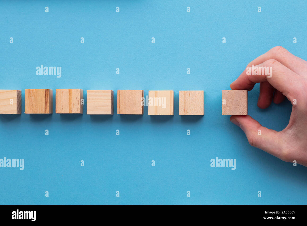 Hand choosing a wooden block from a set. Business choice concept Stock ...