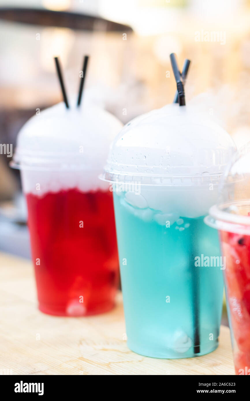 Multi-colored fruit drink with outgoing steam. Non alcoholic cocktail ...