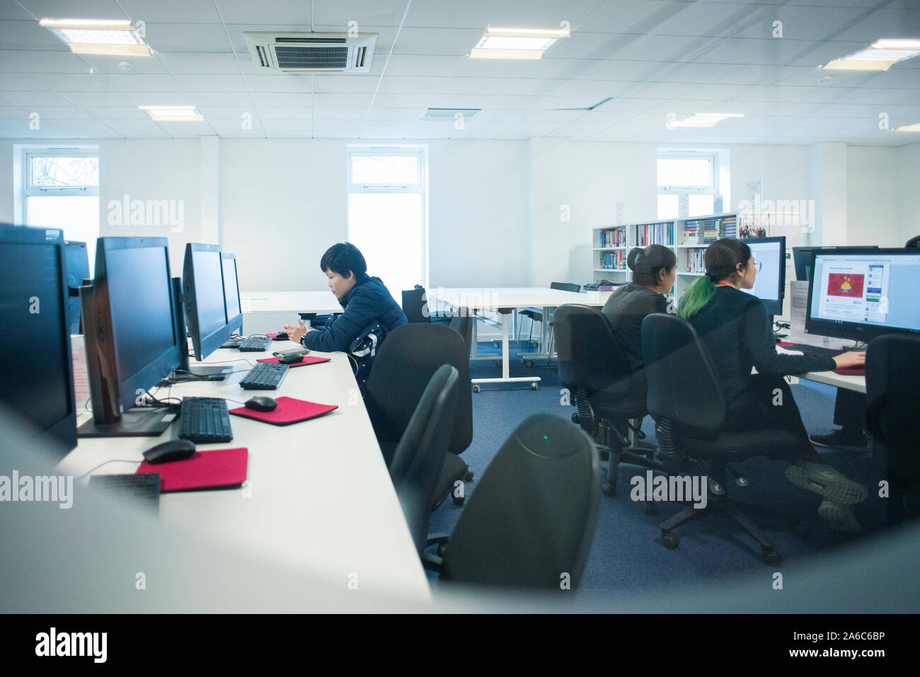 International students reading and working in the college library Stock ...