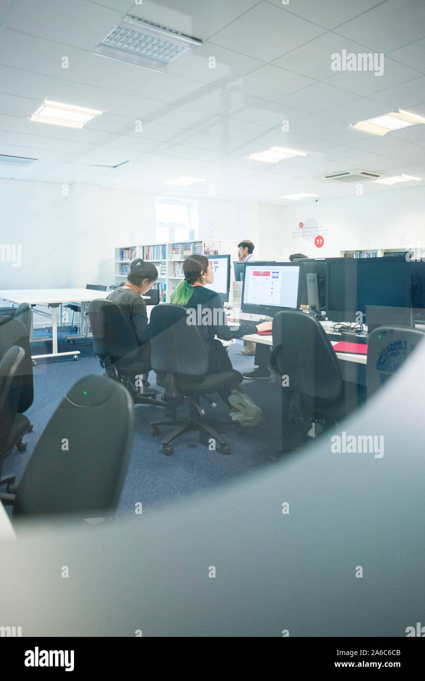 International students reading and working in the college library Stock ...
