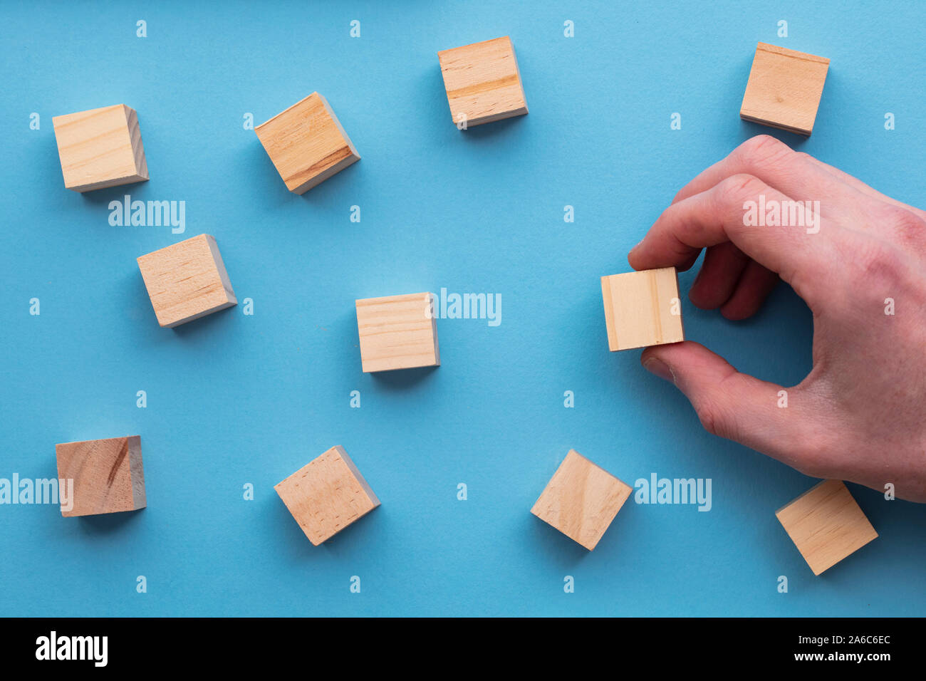 Hand choosing a wooden block from a set. Business choice concept Stock ...