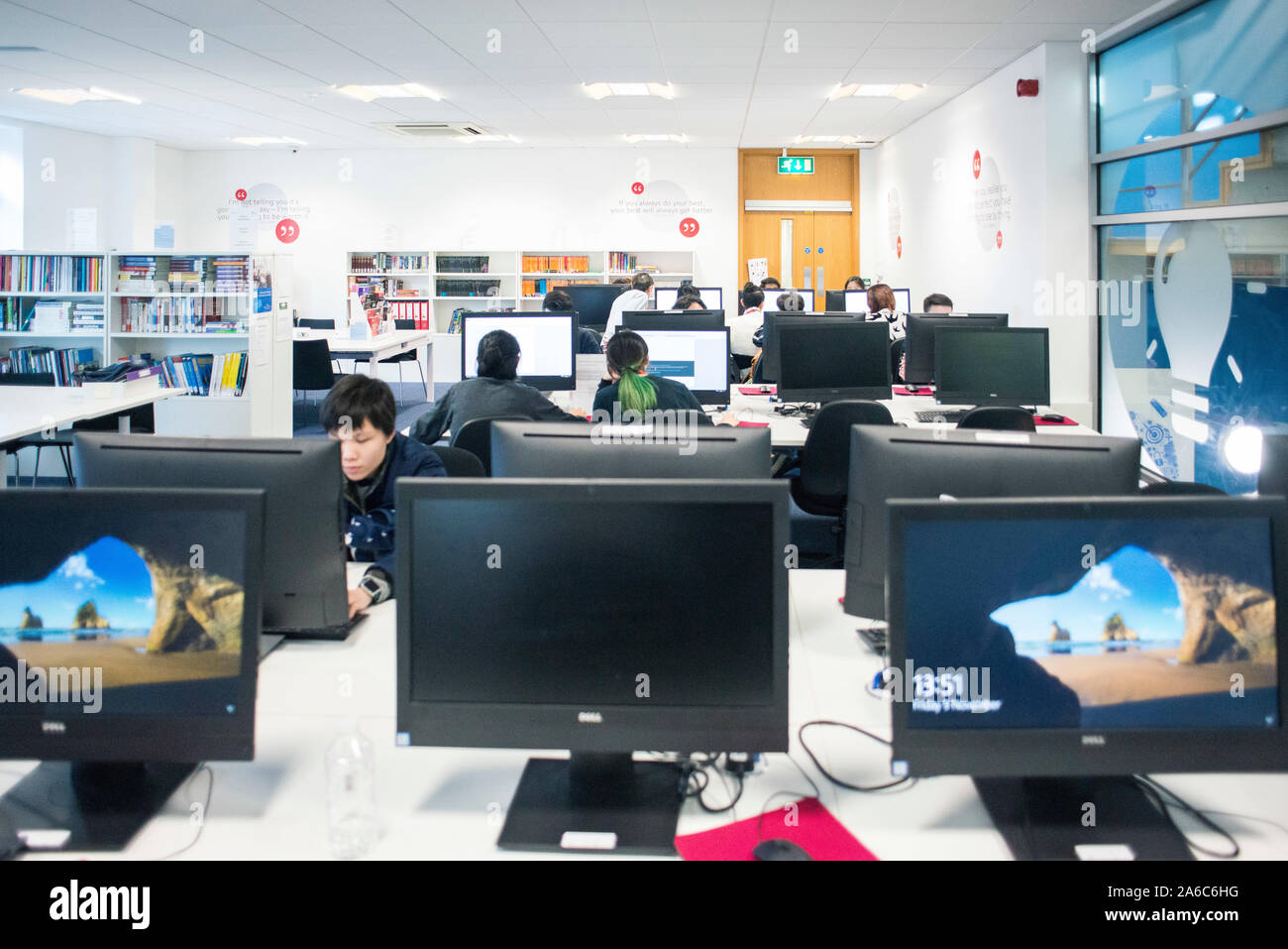 International students reading and working in the college library Stock ...