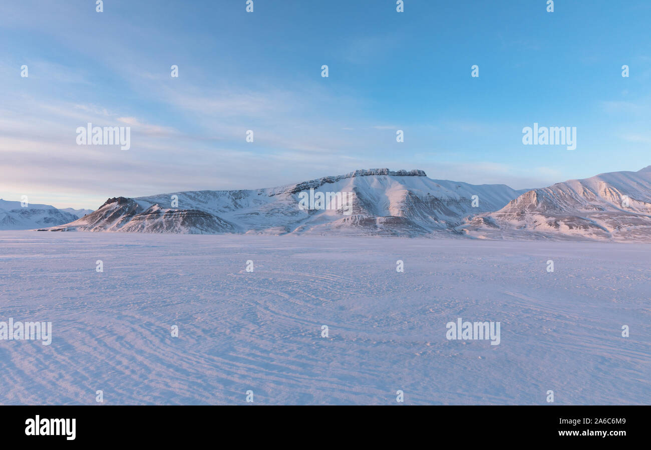 Arctic winter landscape with frozen fjord and snow covered mountains on ...