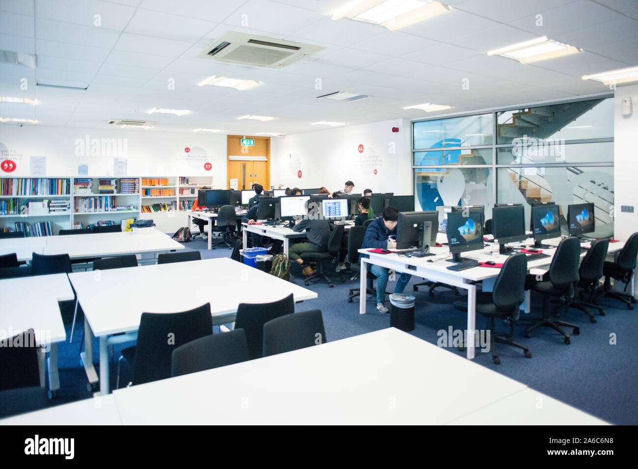 International students reading and working in the college library Stock ...