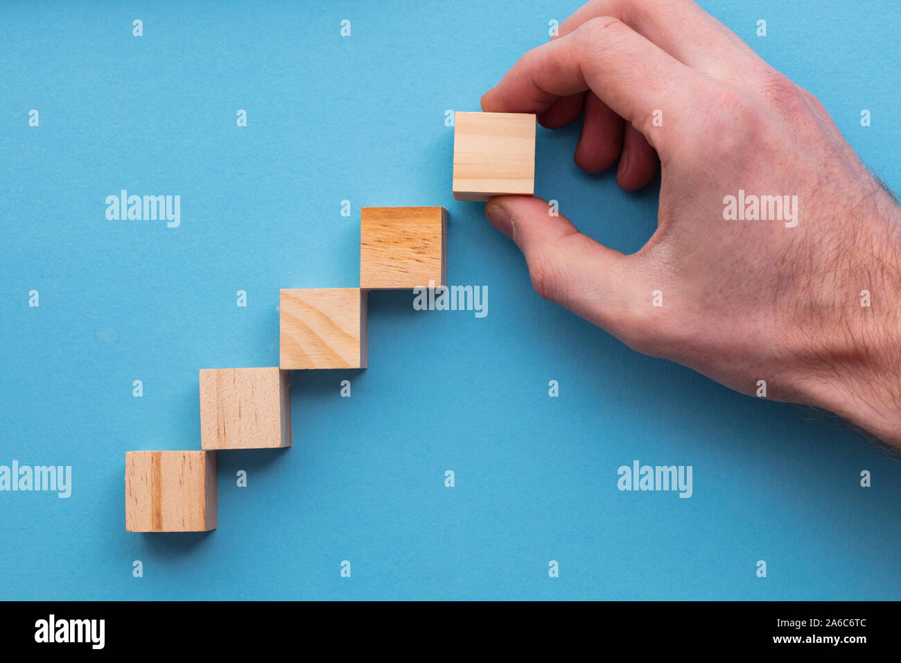 Hand choosing a wooden block from a set. Business choice concept Stock ...