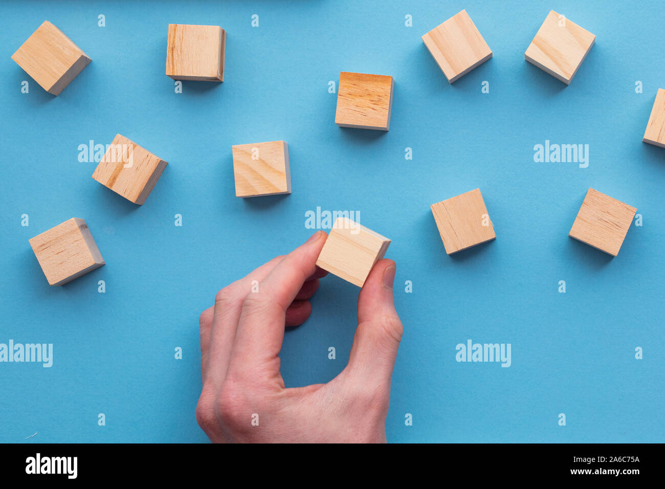 Hand choosing a wooden block from a set. Business choice concept Stock ...