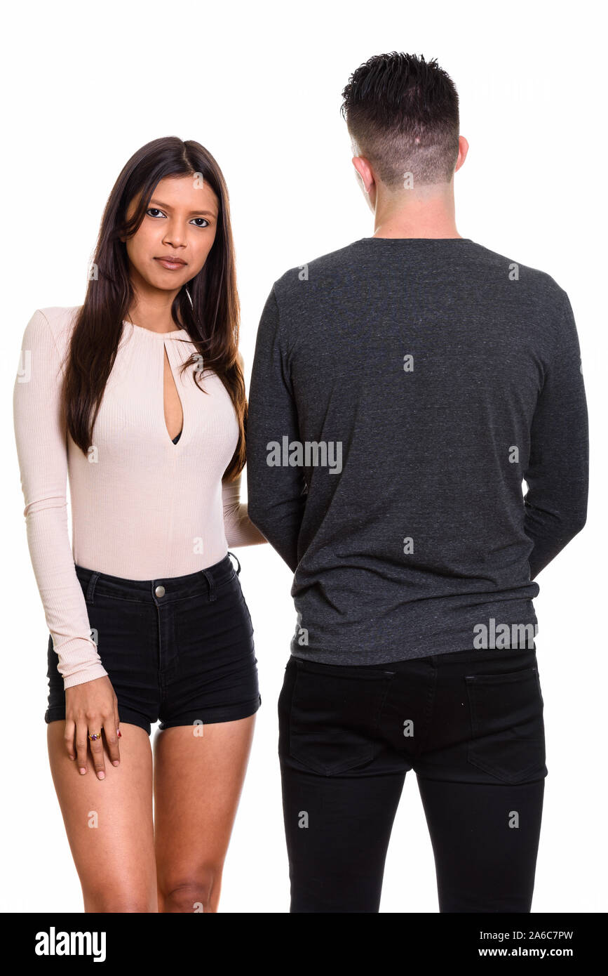 Studio shot of young couple with back view man Stock Photo - Alamy