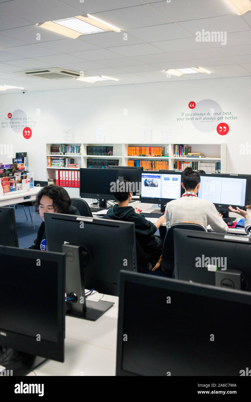 International overseas students sitting in a University library reading ...