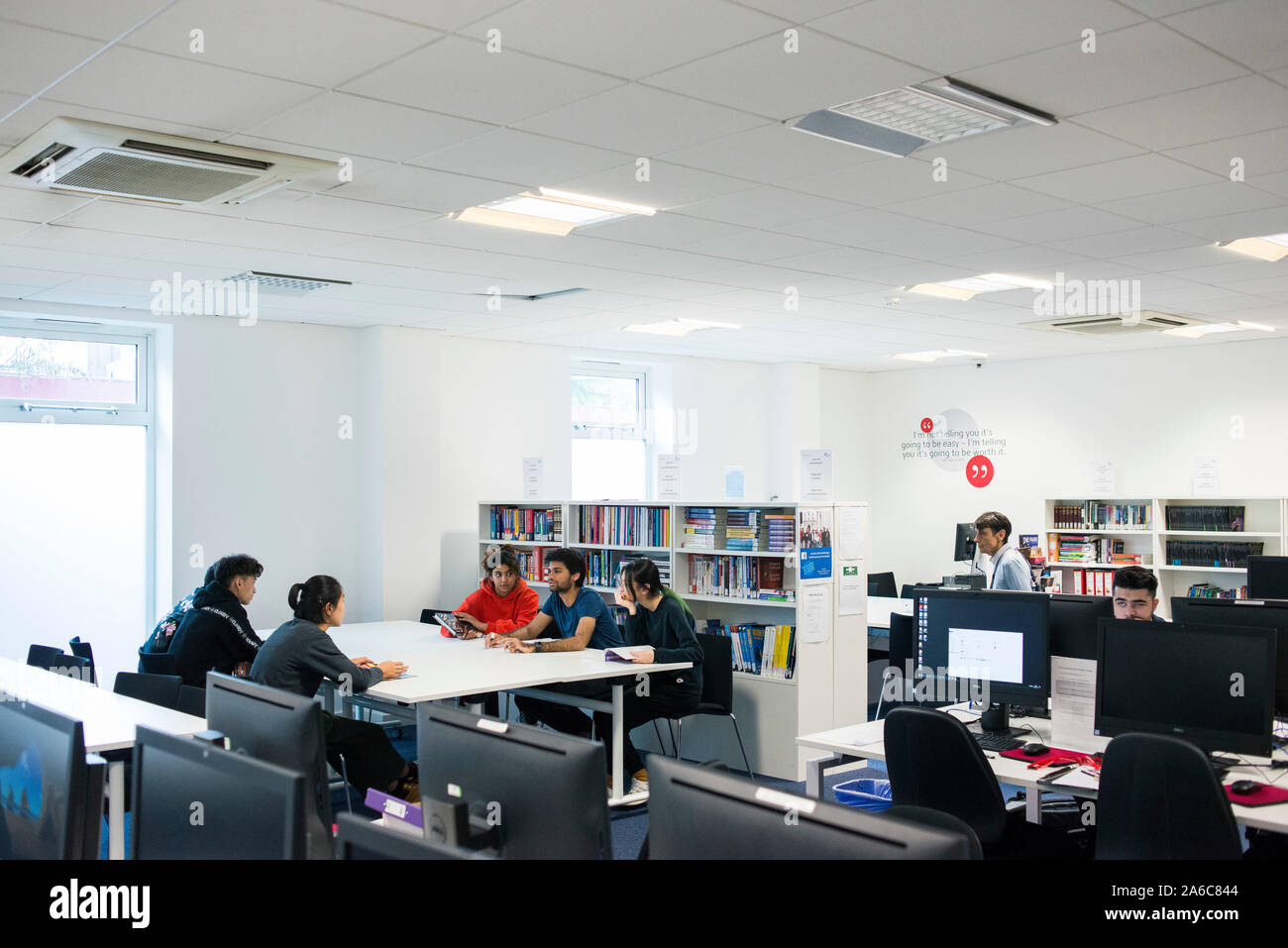 International overseas students sitting in a University library reading ...