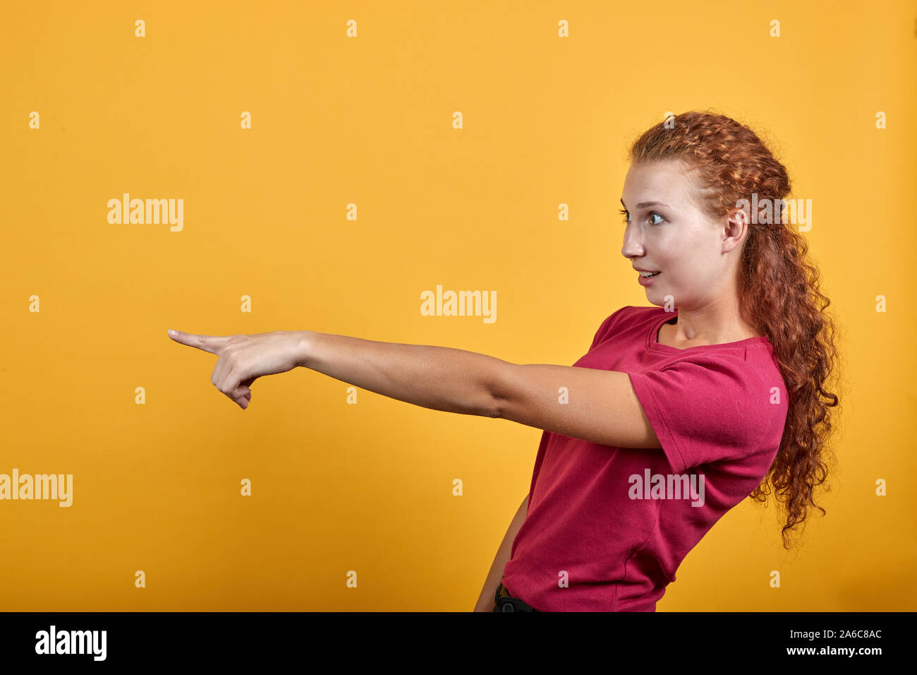Charming woman pointing side hi-res stock photography and images - Alamy