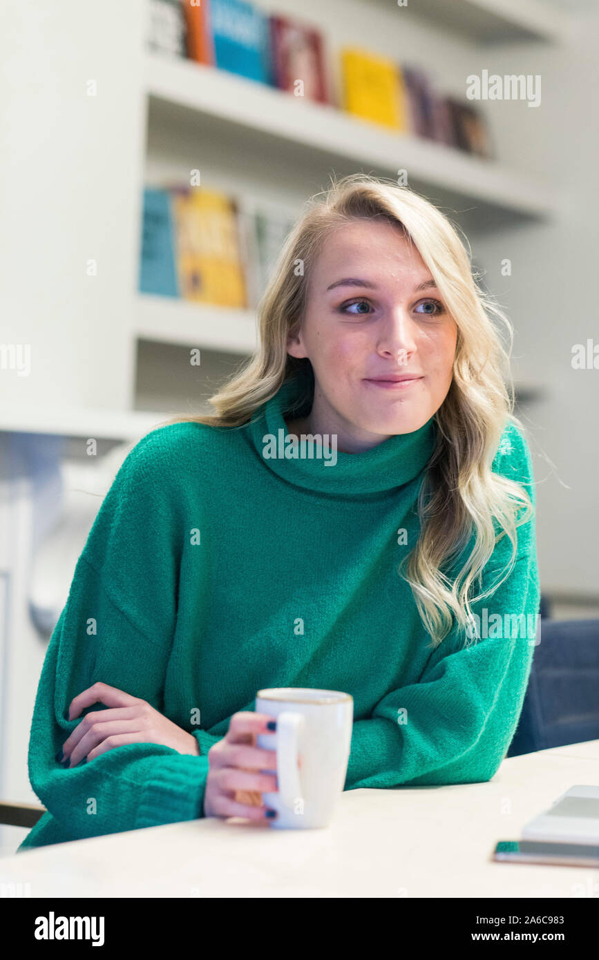 A female office worker poses for an informal profile photo of them ...