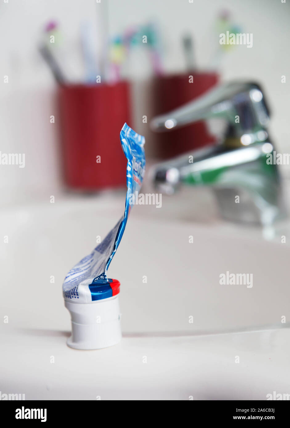 An empty toothpaste tub on wash basin in a bathroom.Photo Jeppe ...