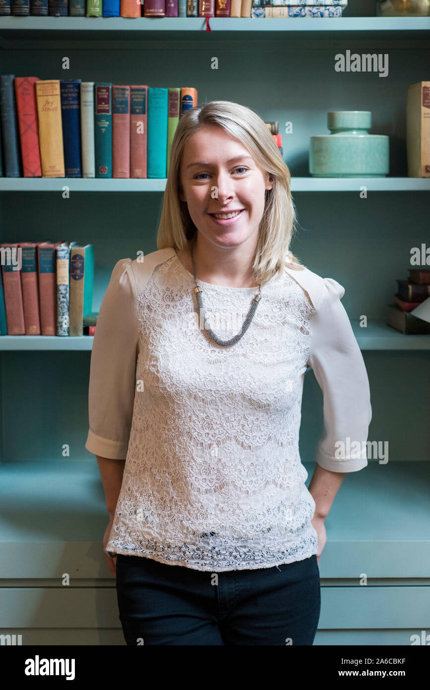A female office worker poses for an informal profile photo of them ...